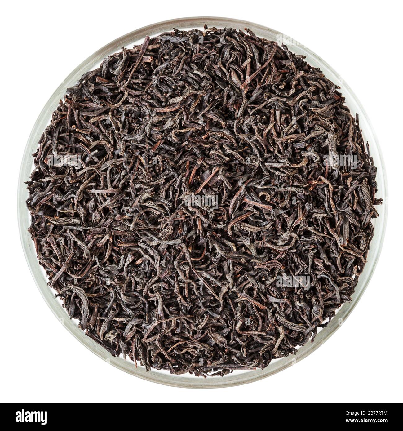 Dry black tea in glass bowl isolated on white background with clipping ...