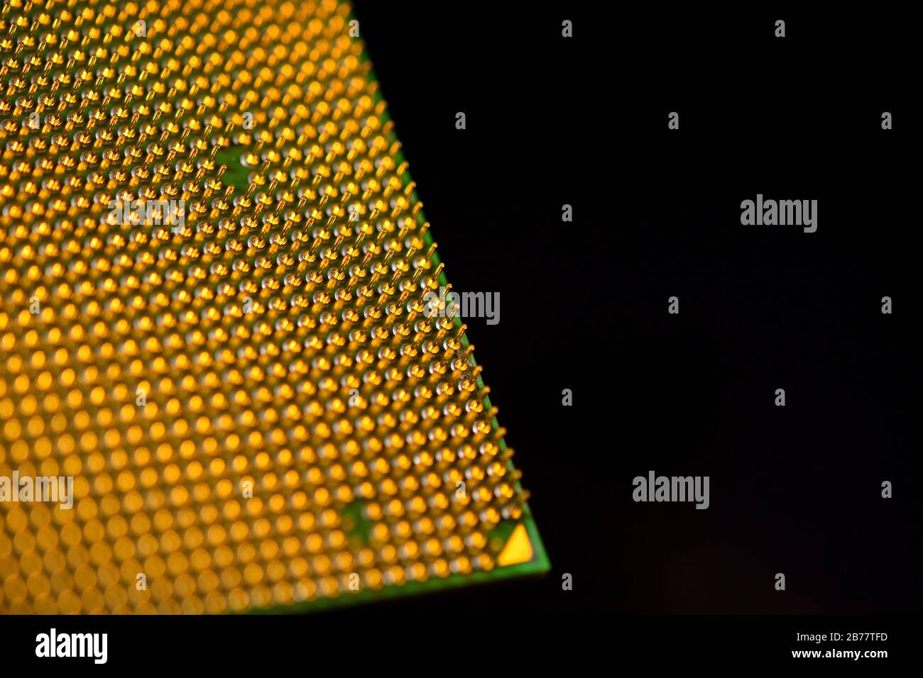 CPU - central processor unit upside-down on a black background. Pins ...