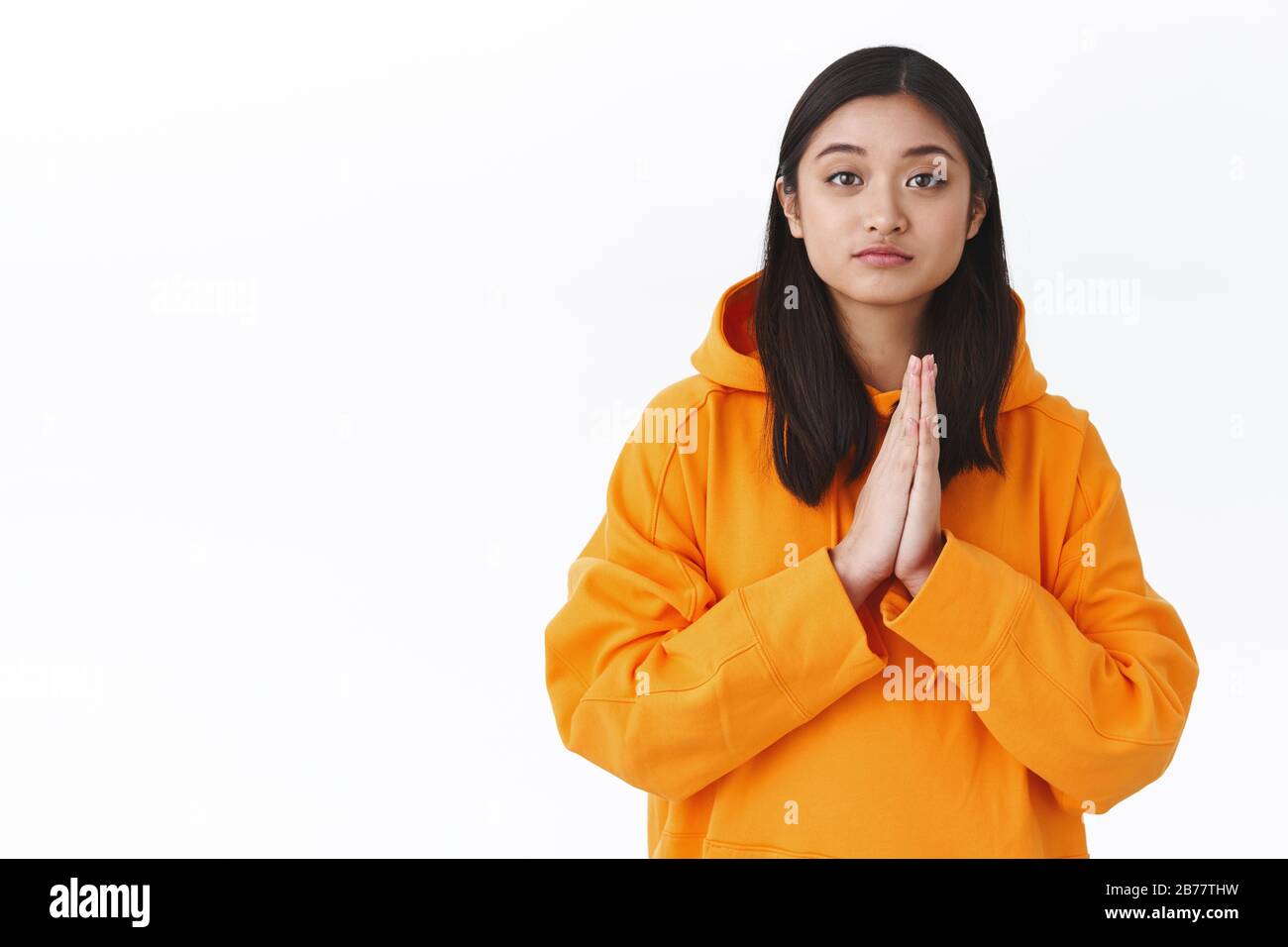 Waist-up portrait attractive asian female student in orange hoodie ...