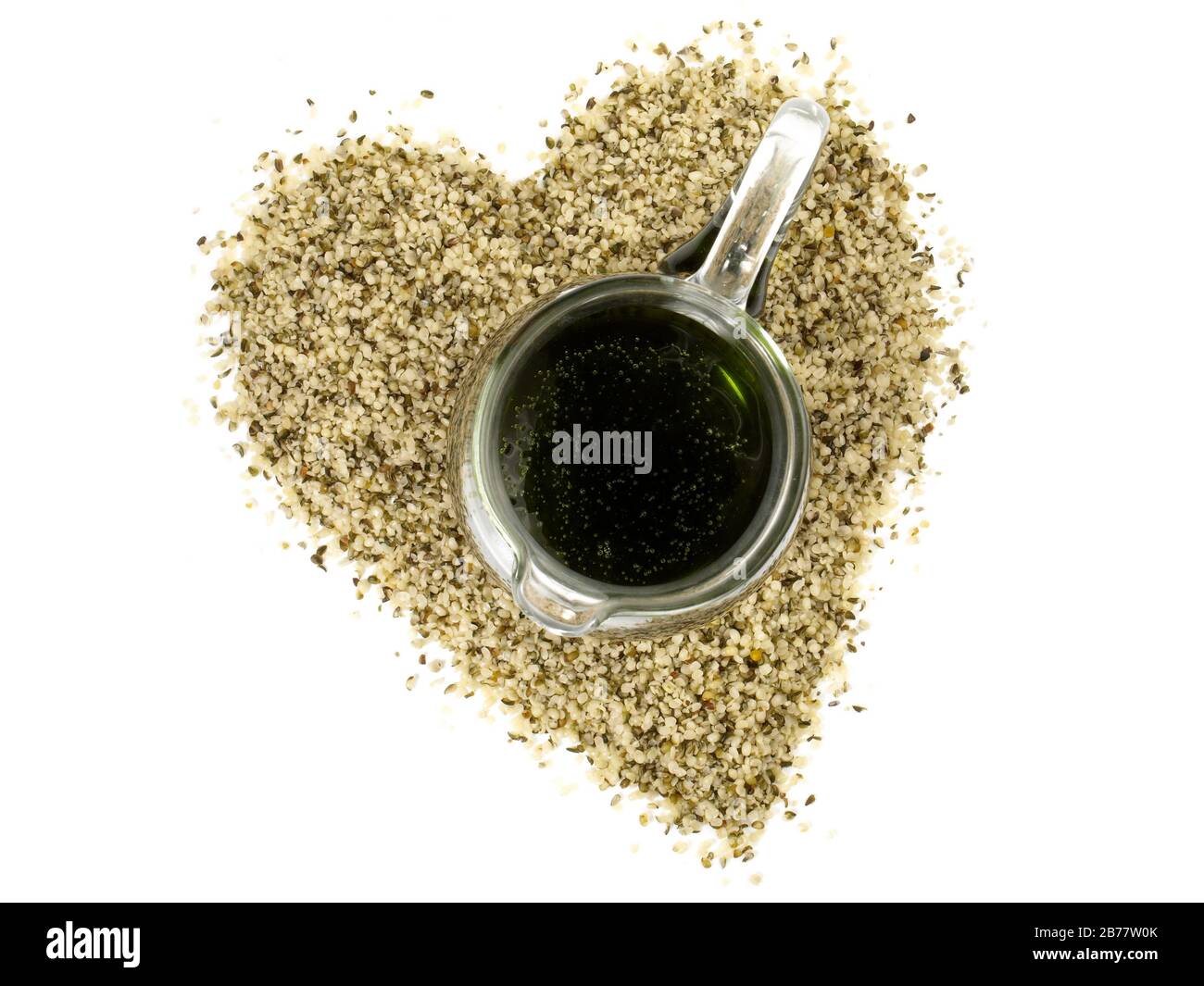 Shelled Hemp Seeds in Heart Shape with Hemp Oil isolated on white ...