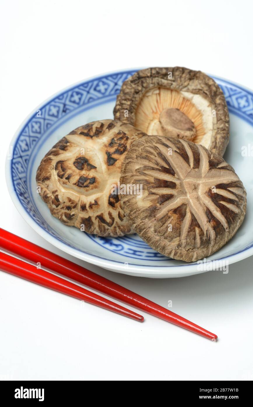 Dried shiitake mushrooms in bowls and chopsticks hi-res stock ...
