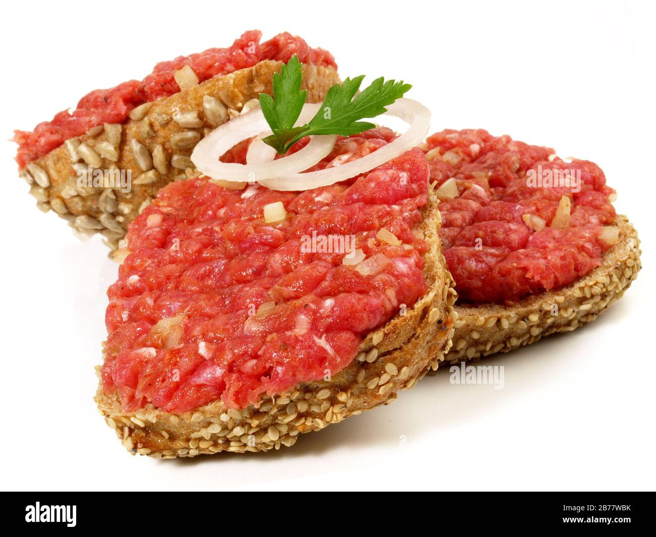 Spicy Beef Tartar Meat on a Bread Roll with Onions Stock Photo - Alamy