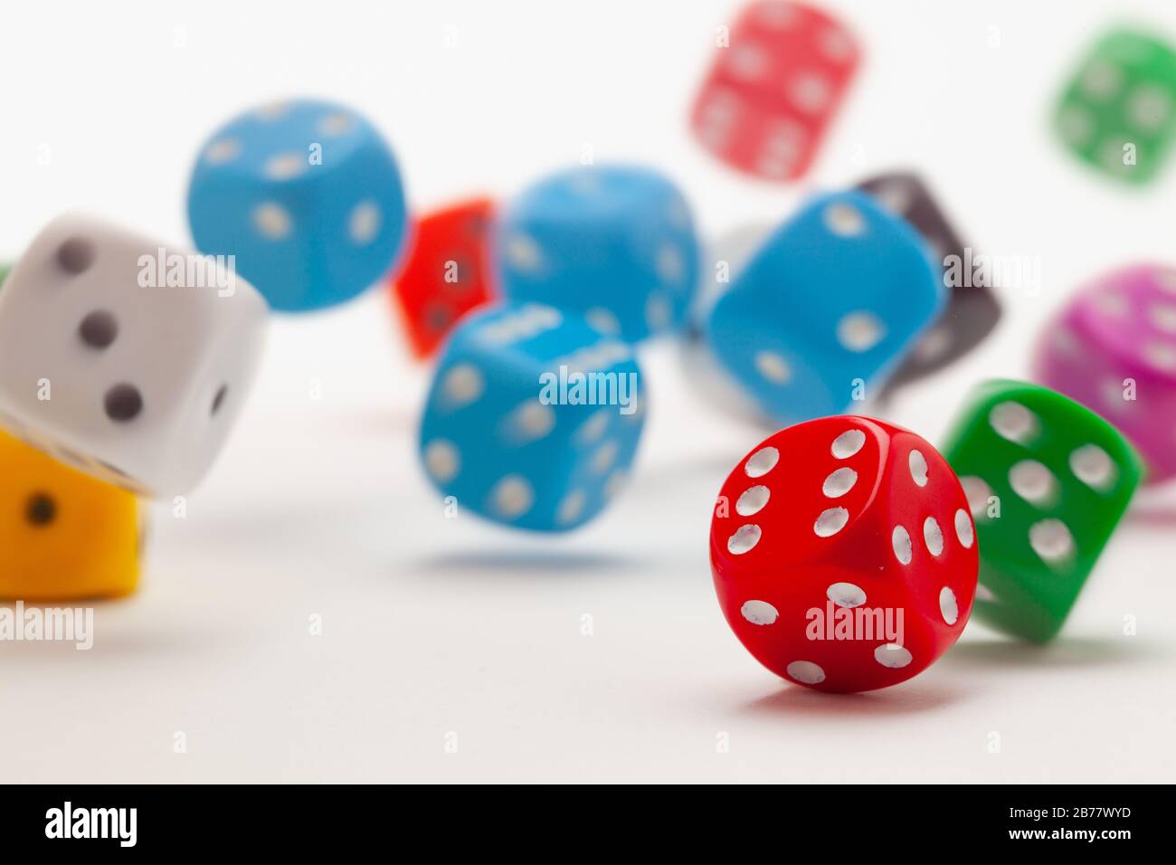 Playing dice at white wooden background. Playing a game with dice ...