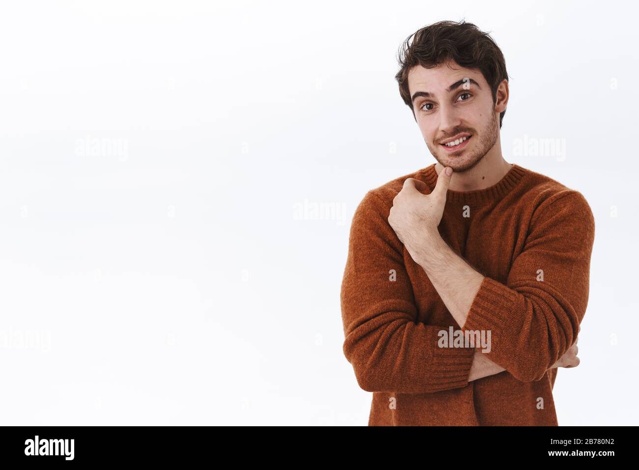 Waist Up Portrait Of Interested Handsome Young Male Listening Curious