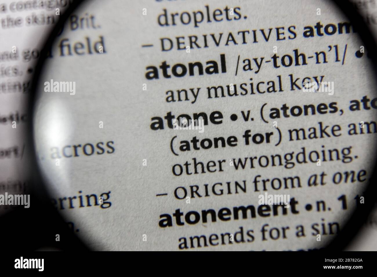 The word or phrase atone in a dictionary book Stock Photo - Alamy