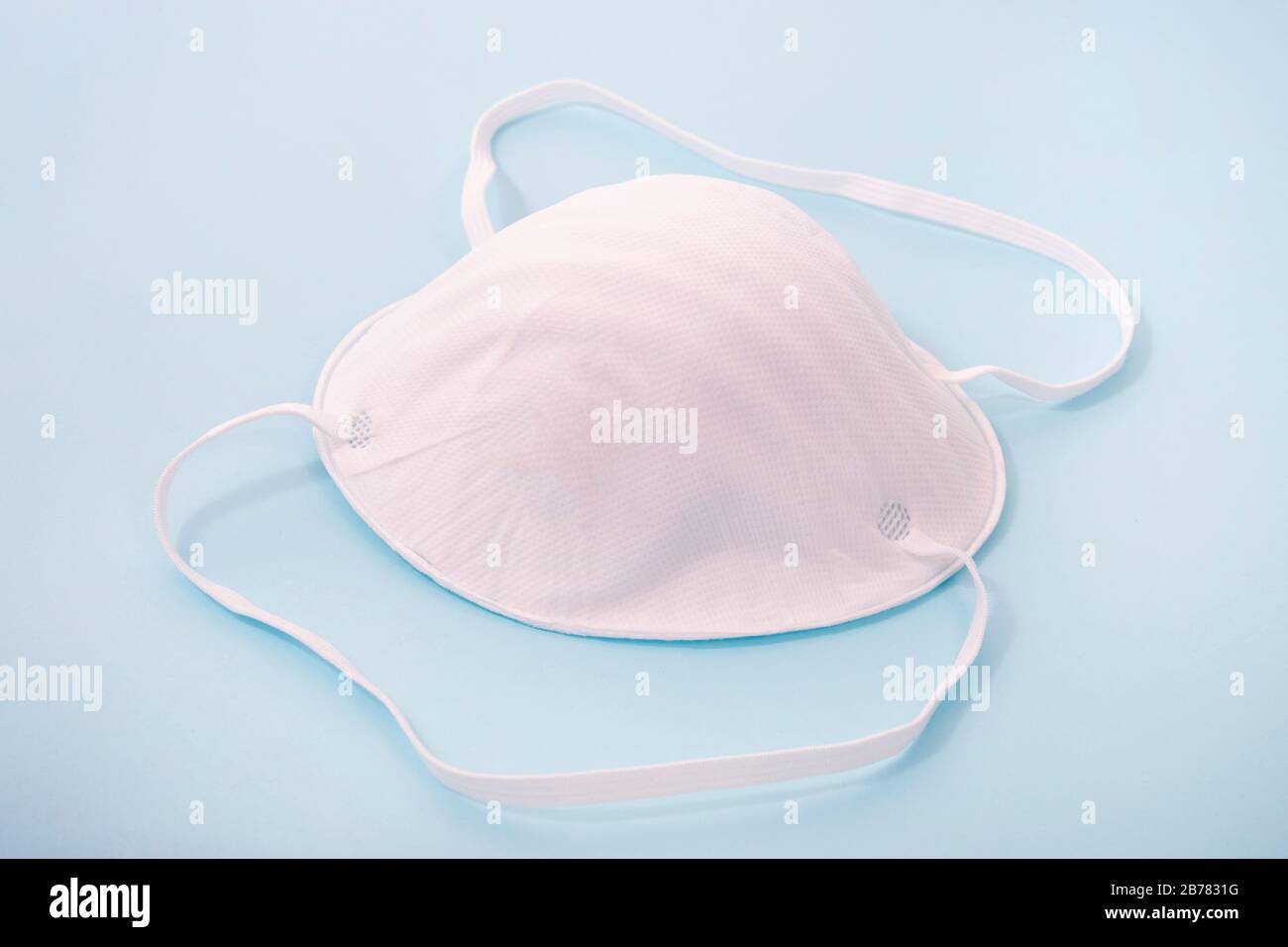face mask or dust mask isolated on a light blue background Stock Photo ...
