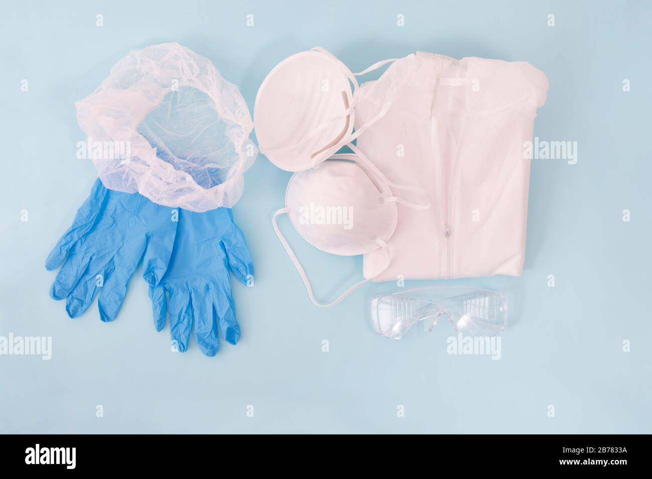 dust mask, blue gloves, protective suit and head cover isolated on a ...