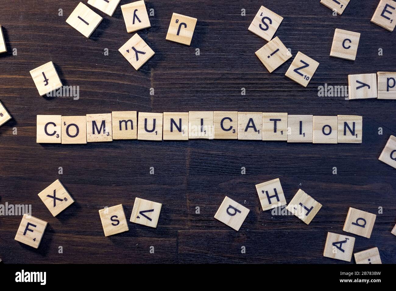 communication word made with scrabble letters on a black wooden table ...