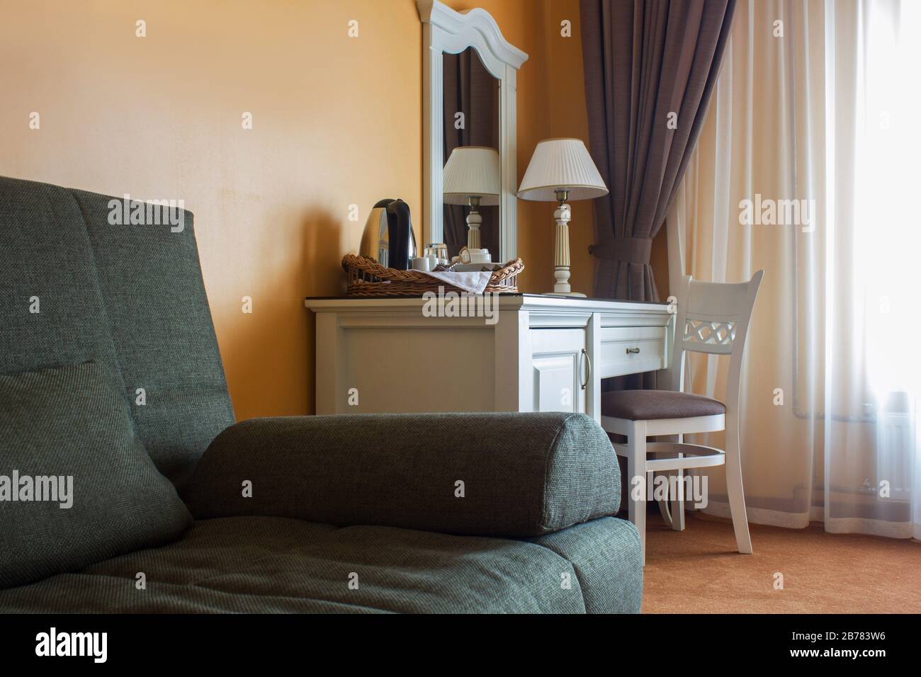 Nice hotel room with sofa and window Stock Photo - Alamy