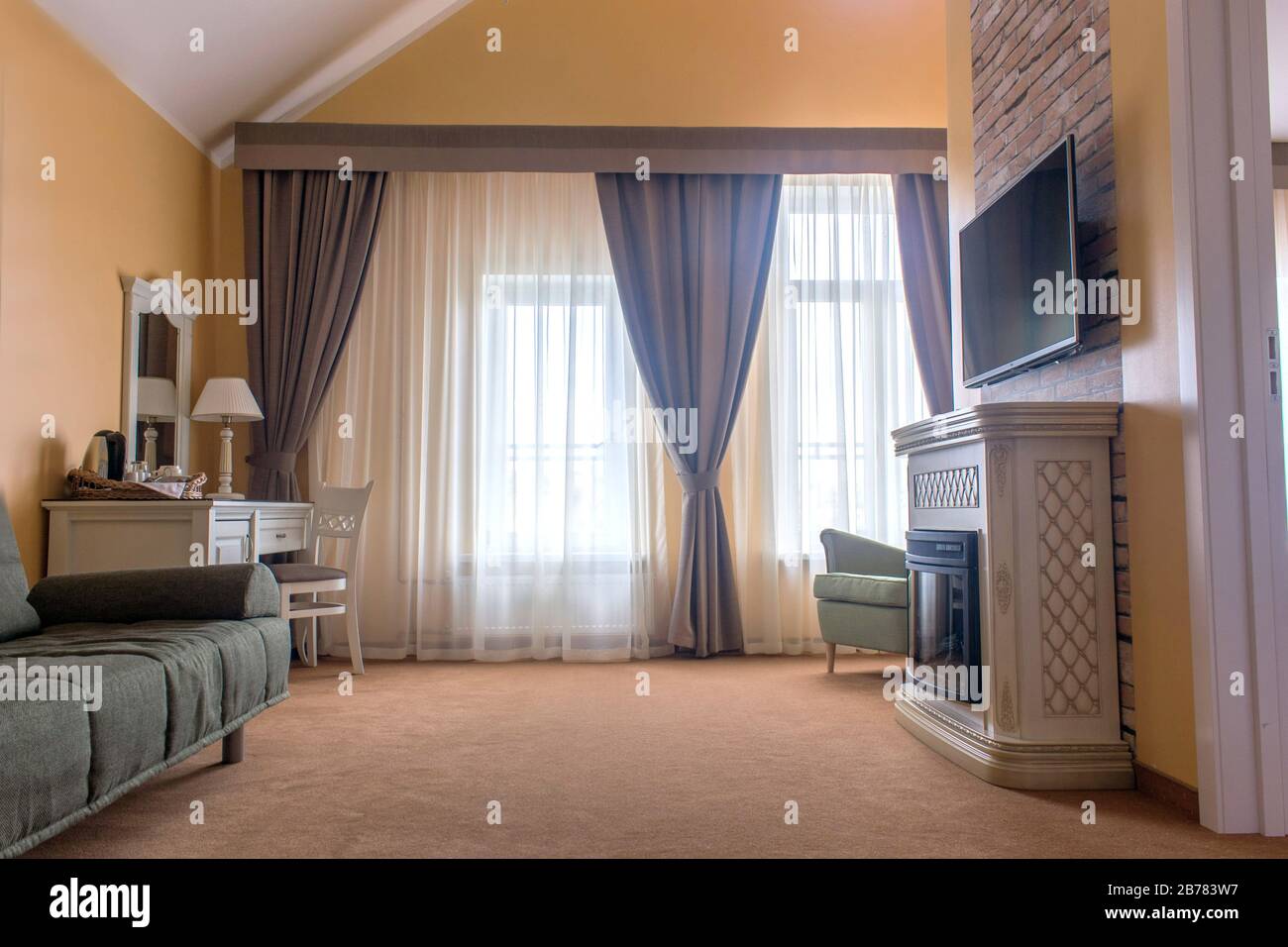 Nice hotel room with sofa and window Stock Photo - Alamy