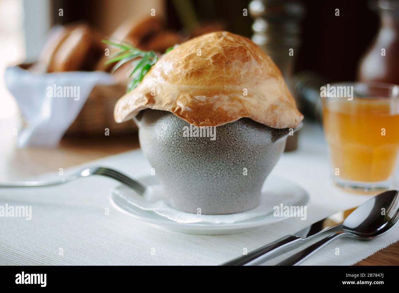 Vegetables in a pot baked with the bread as cap Stock Photo - Alamy