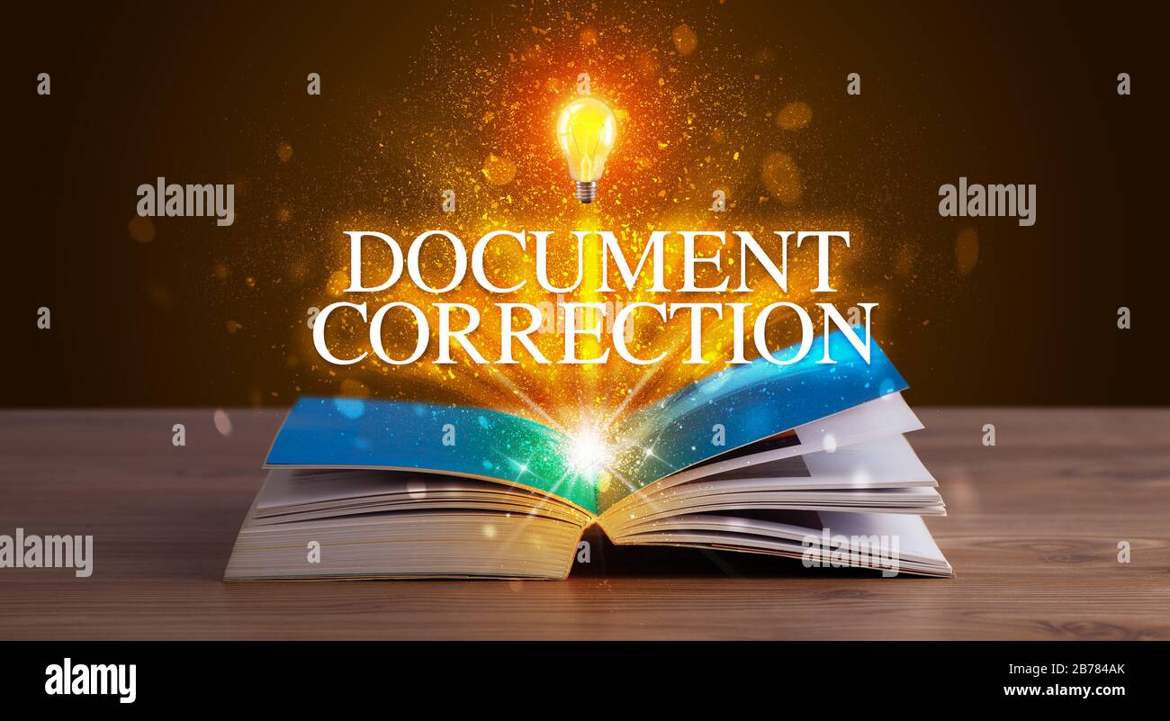 DOCUMENT CORRECTION inscription coming out from an open book ...