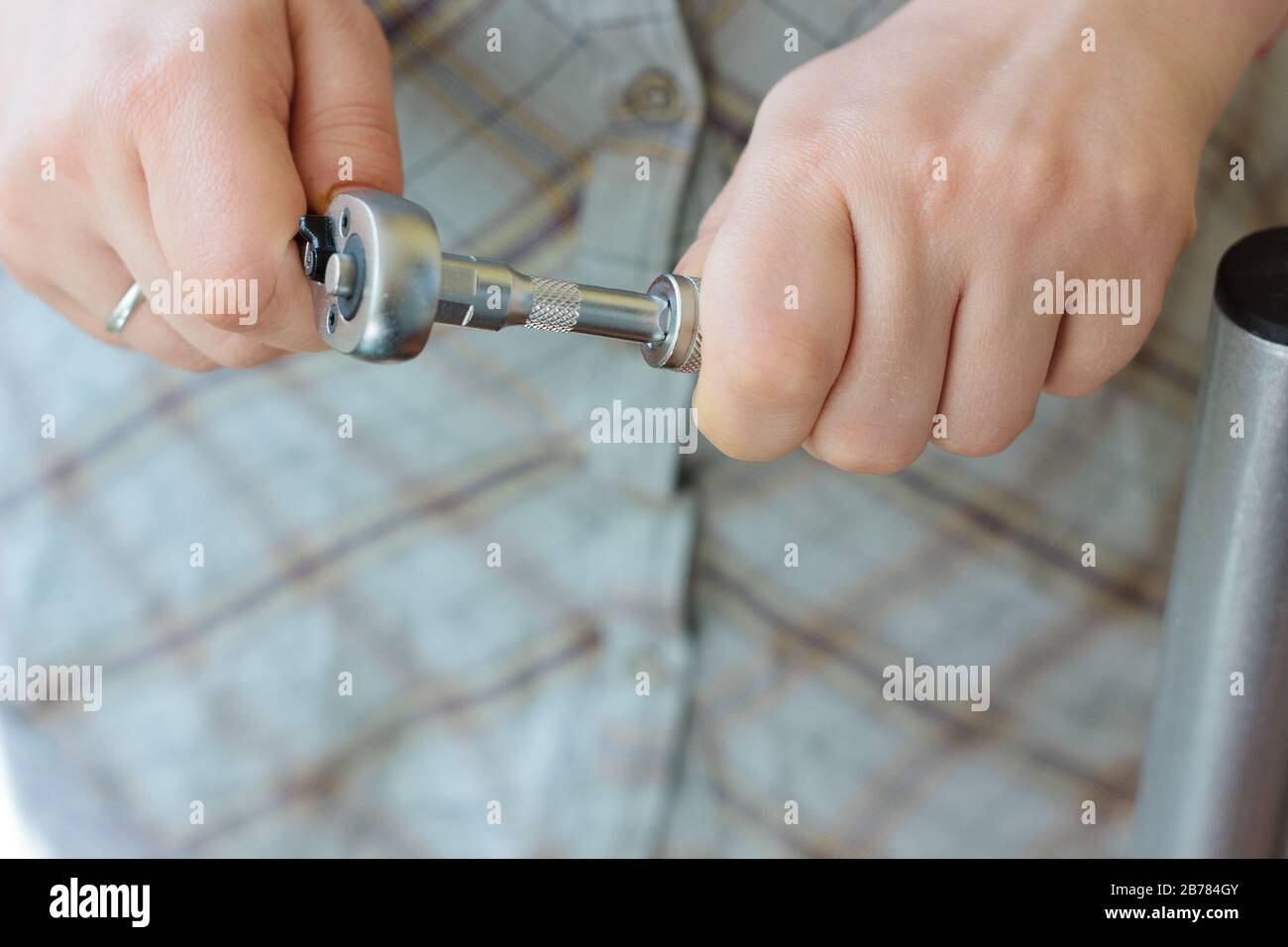 Hands putting ratchet on a socket wrench Stock Photo - Alamy