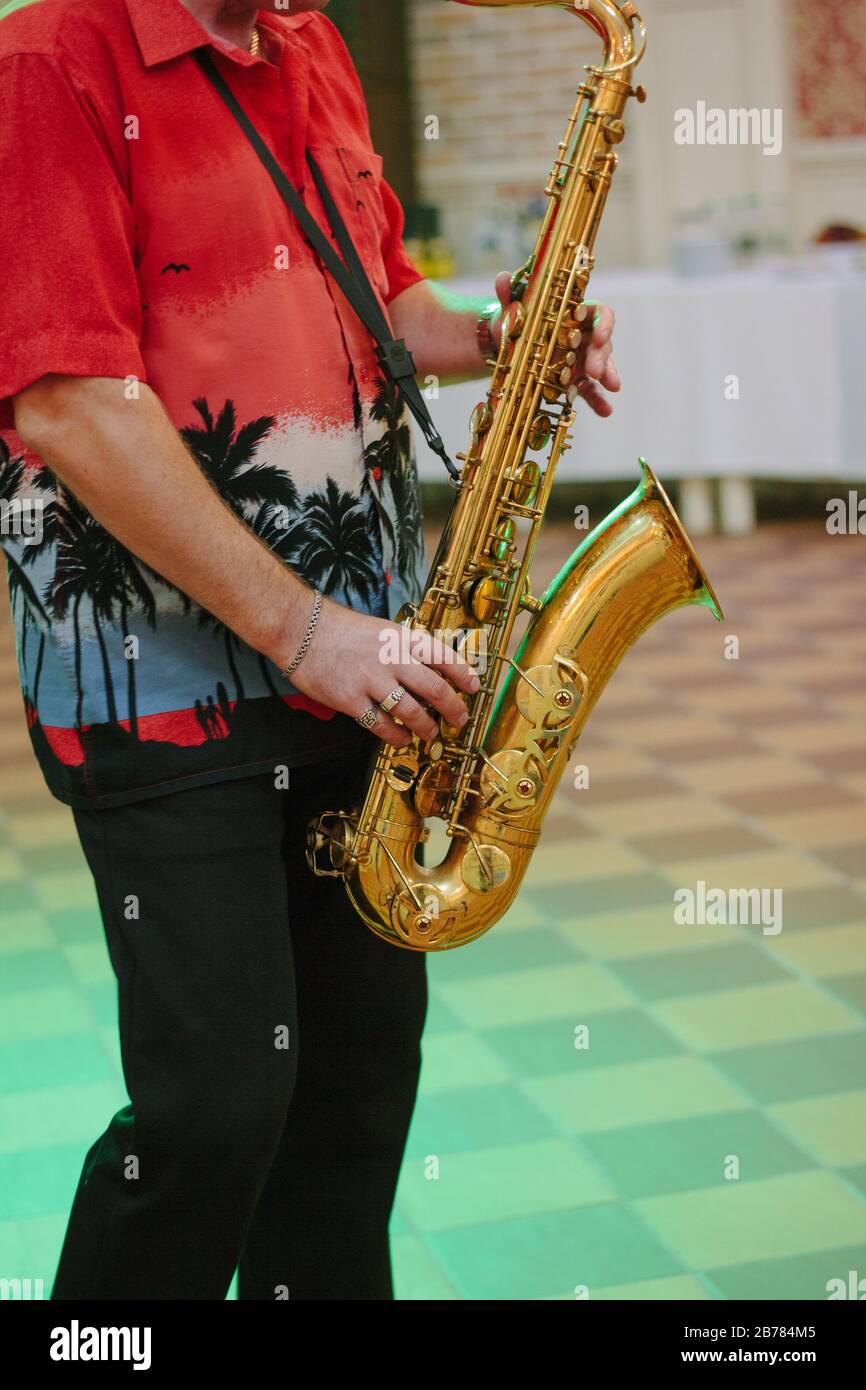 Musician playing on the saxophone at room Stock Photo - Alamy
