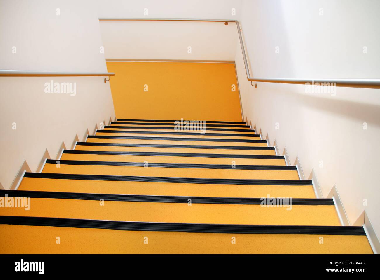Close view of yellow stairs inside of office building Stock Photo - Alamy