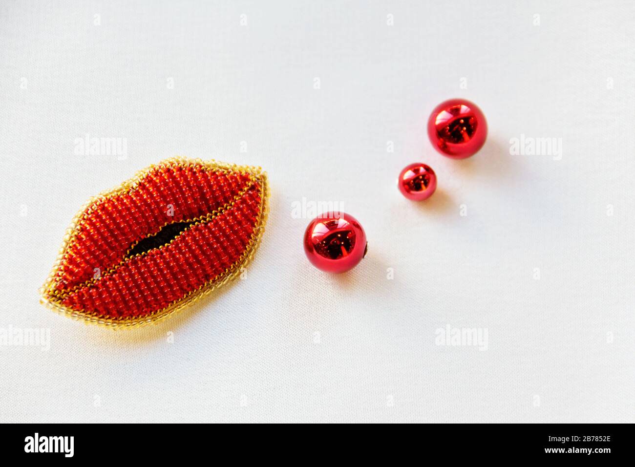 Home craft made of beads on a white background. Homemade crafts in the ...