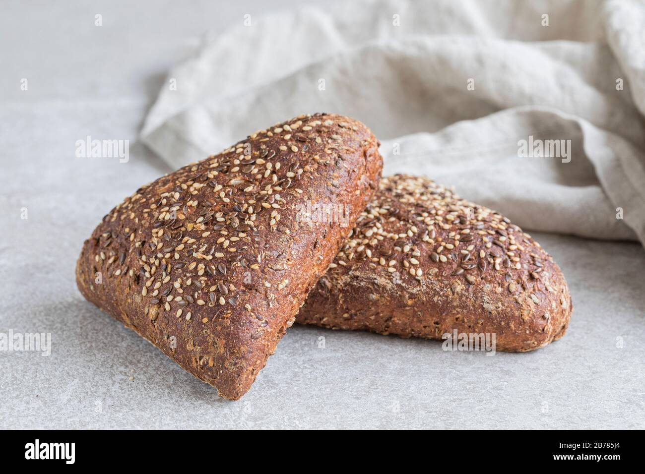 Two pieces of healthy brown bread buns. The triangle shaped breads are ...