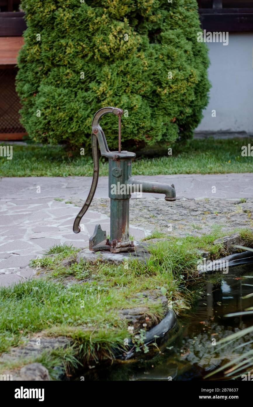 vintage water pump at countryside or village Stock Photo - Alamy