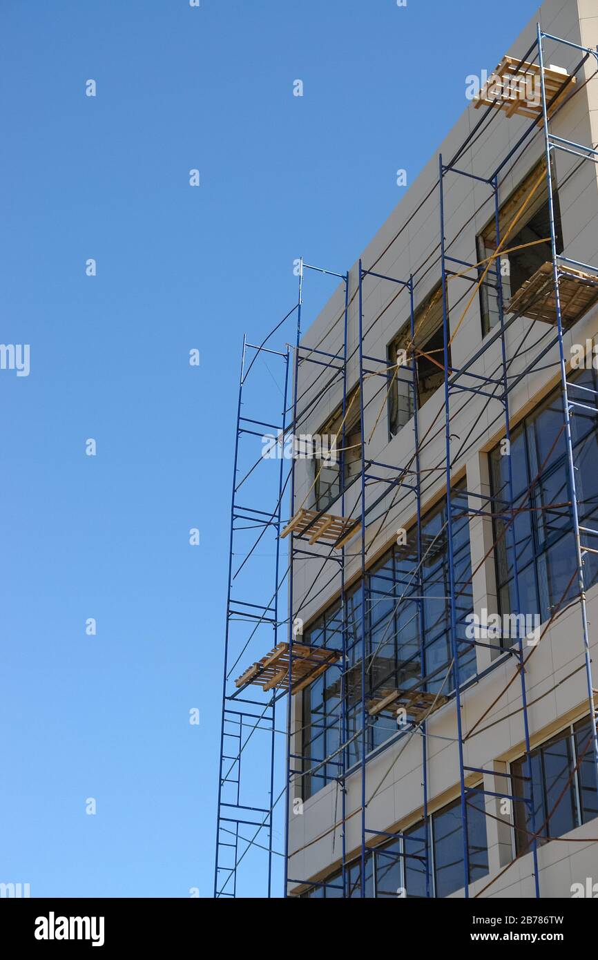 Scaffolding round building with sky at background Stock Photo - Alamy