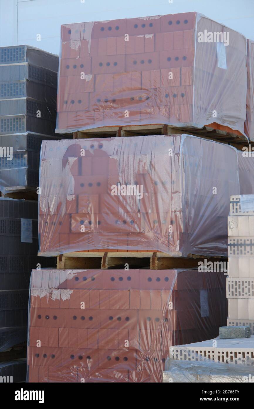 Stacked clay bricks in a plastic package Stock Photo - Alamy