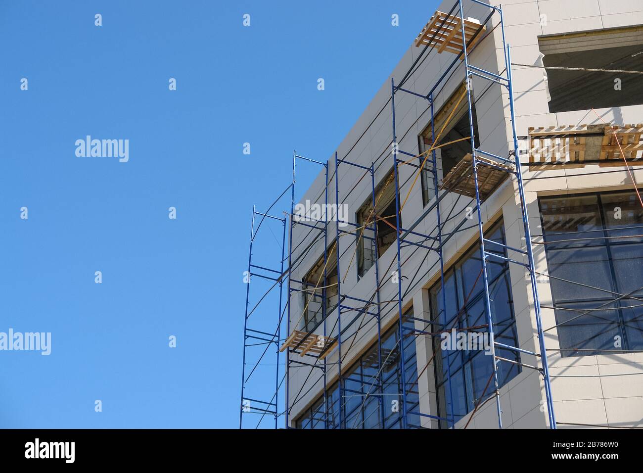 Scaffolding round building with sky at background Stock Photo - Alamy