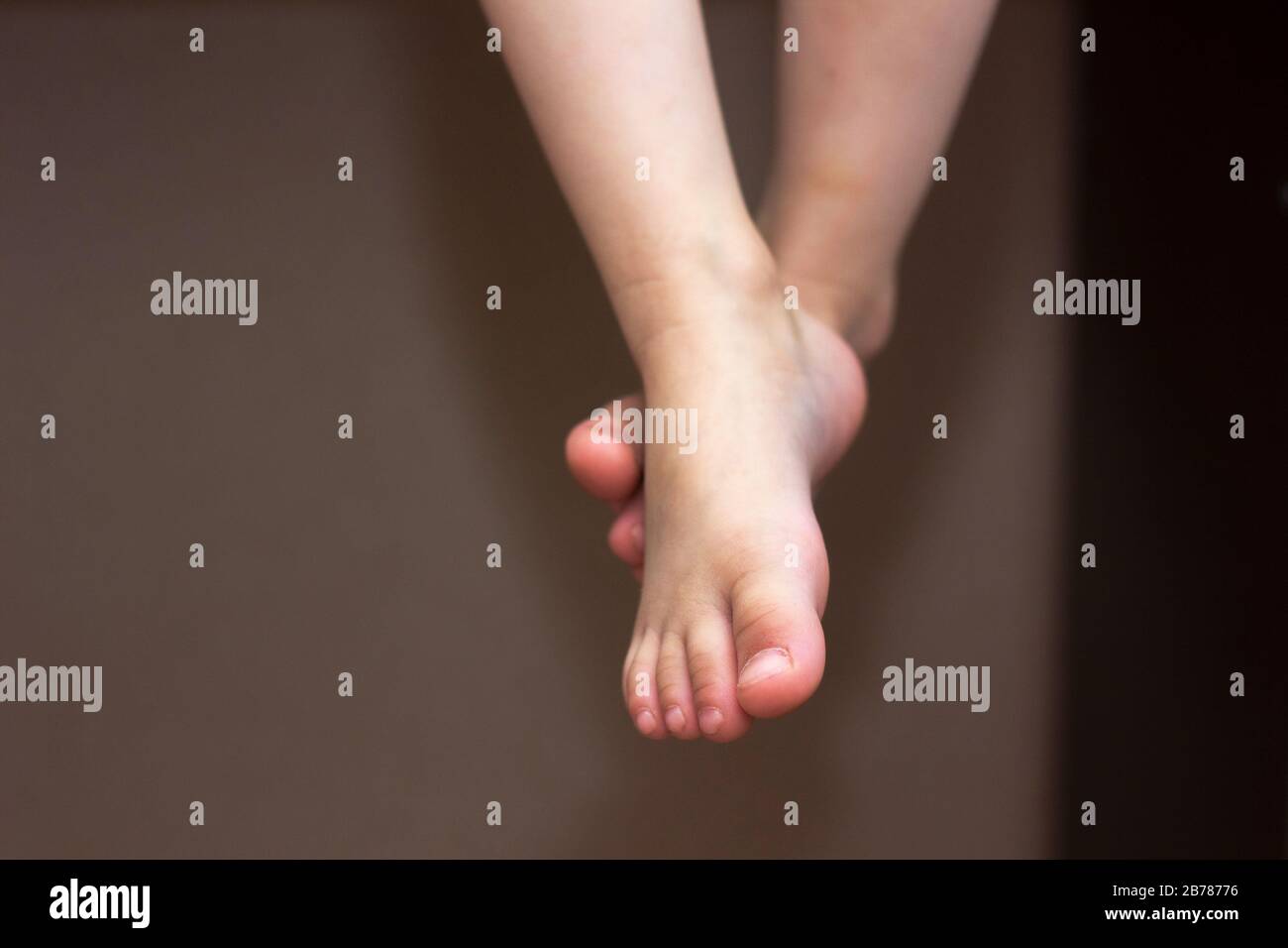 Baby feet. Kid toes while kid sitting on the chair Stock Photo - Alamy
