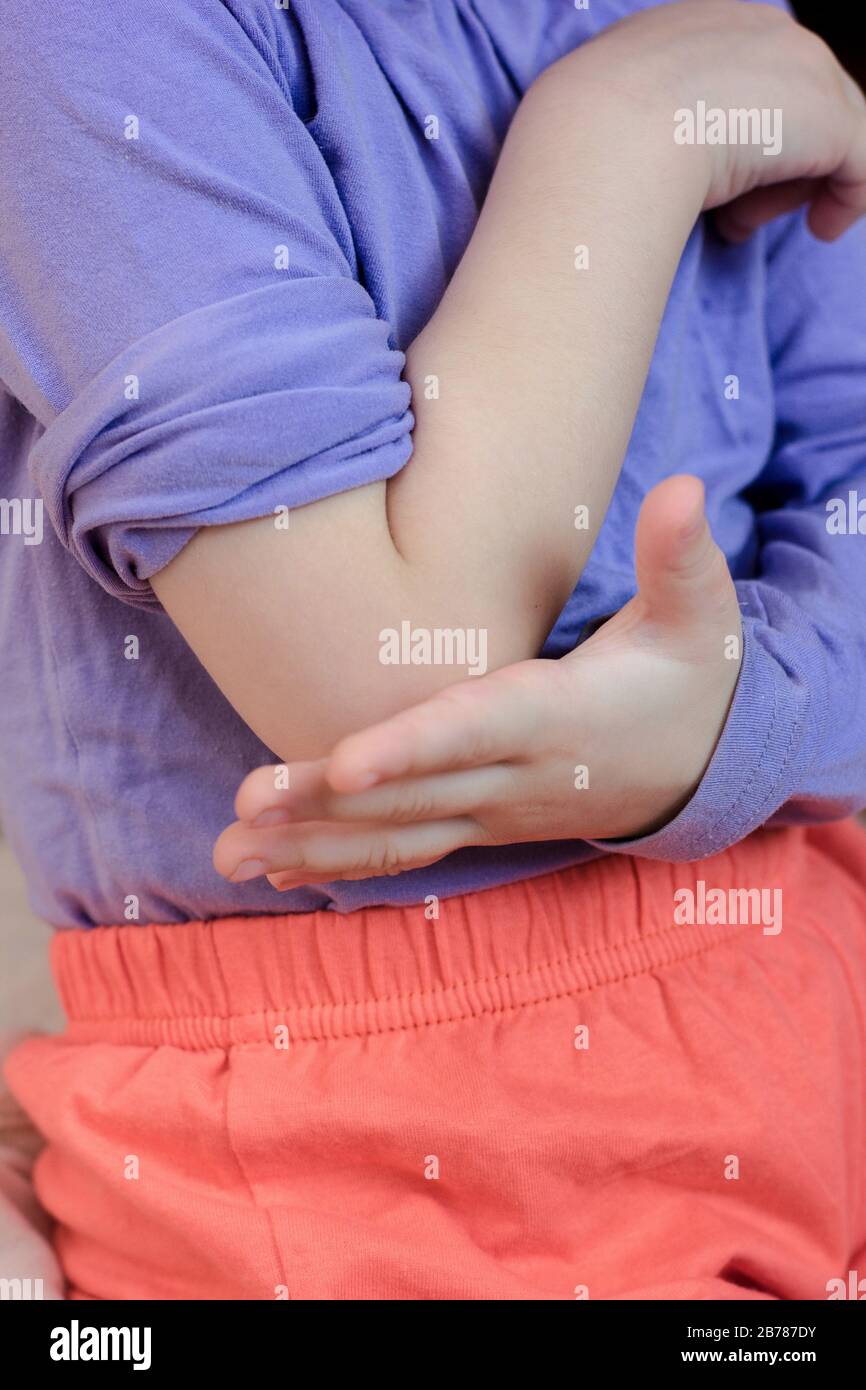 Little kid girl with pain in elbow Stock Photo - Alamy