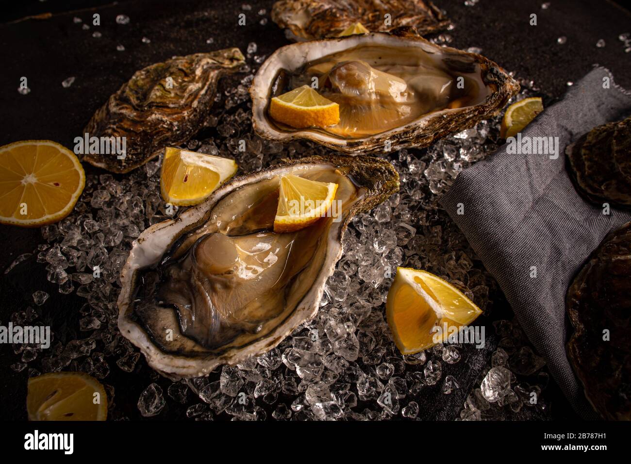 Fresh raw oysters in shells hi-res stock photography and images - Alamy