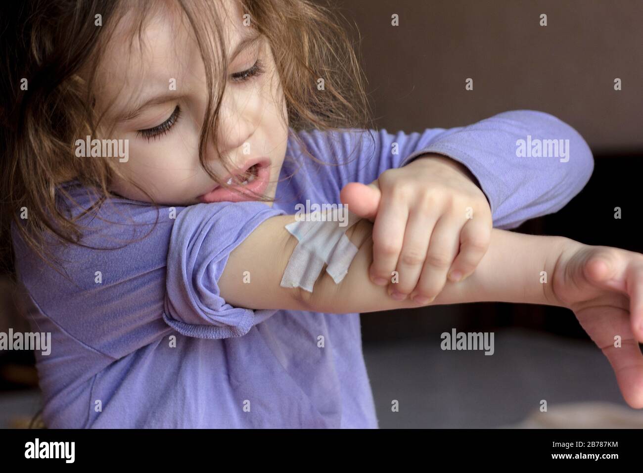 Little kid girl with band aid at elbow Stock Photo - Alamy