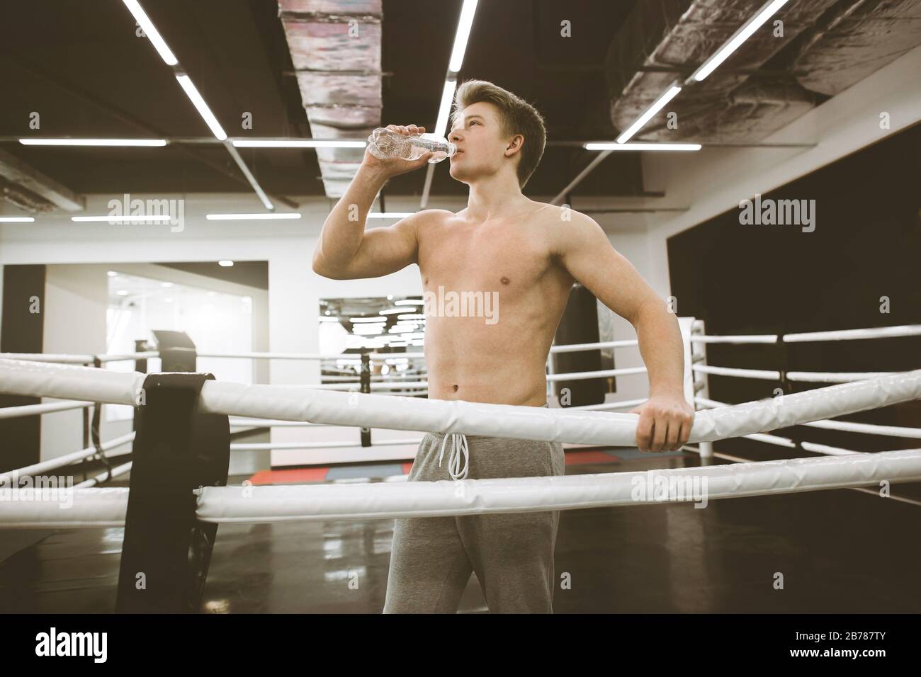 Male boxer drinking water after fight or workout exercising in boxing ...