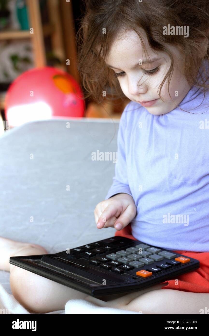 Little kid girl with a calculator in hands Stock Photo - Alamy