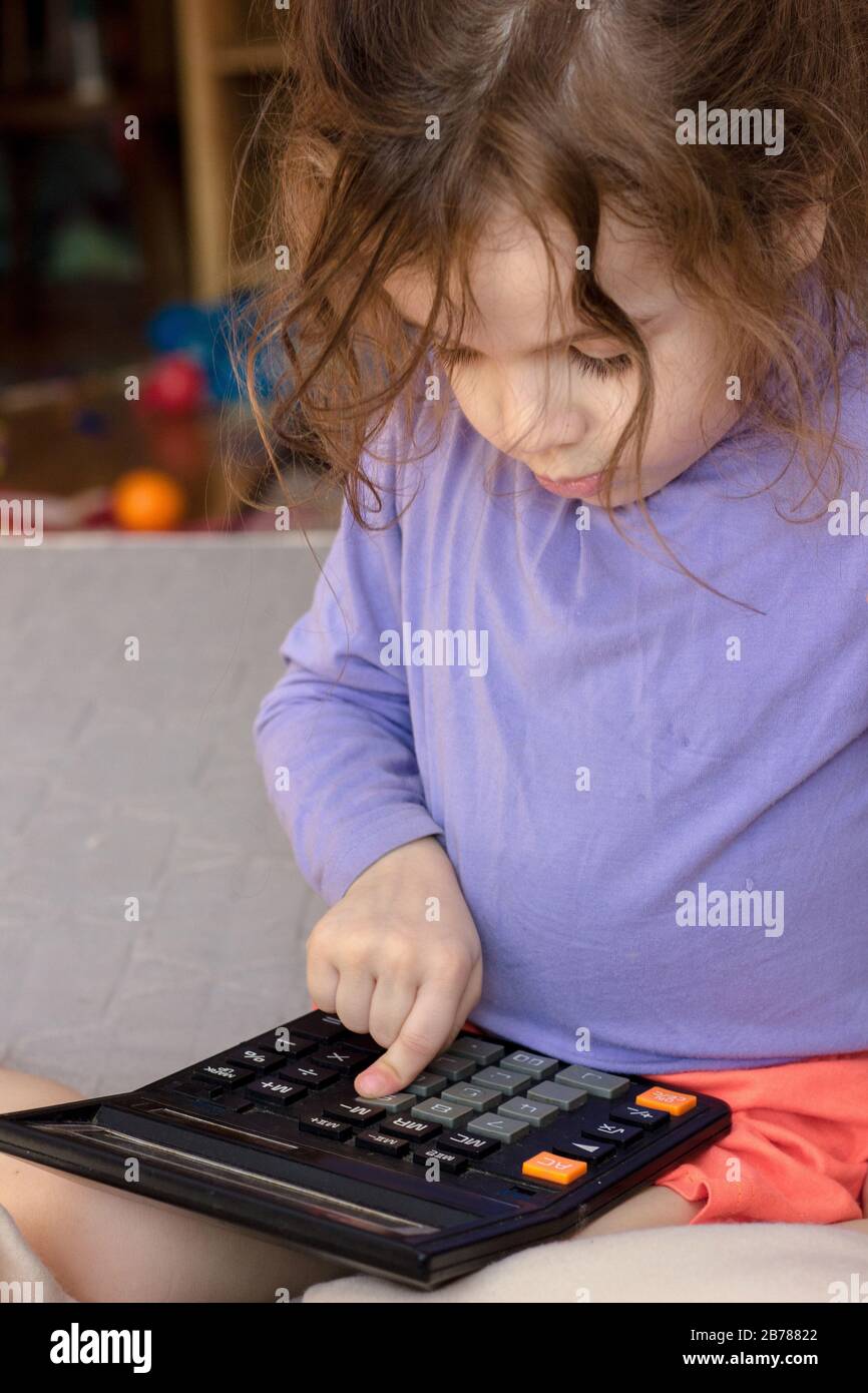Little kid girl with a calculator in hands Stock Photo - Alamy