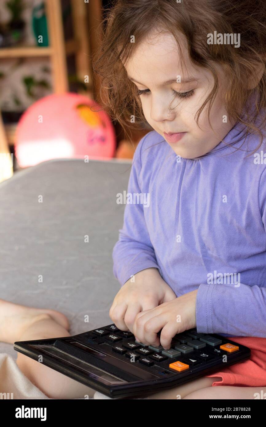 Little kid girl with a calculator in hands Stock Photo - Alamy