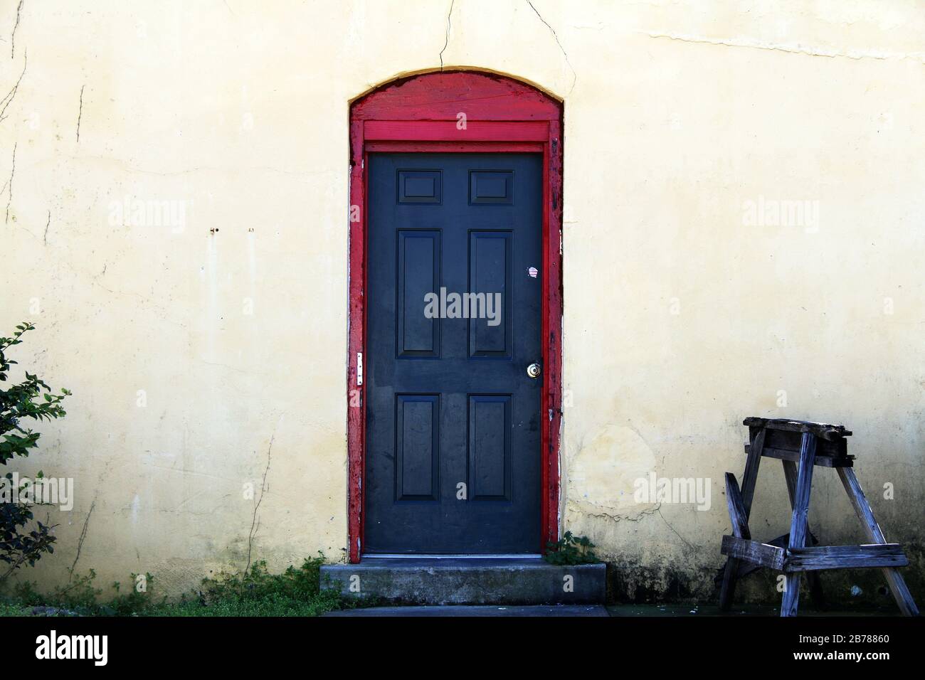 a black door with red trim at a vintage workshop entrance Stock Photo ...