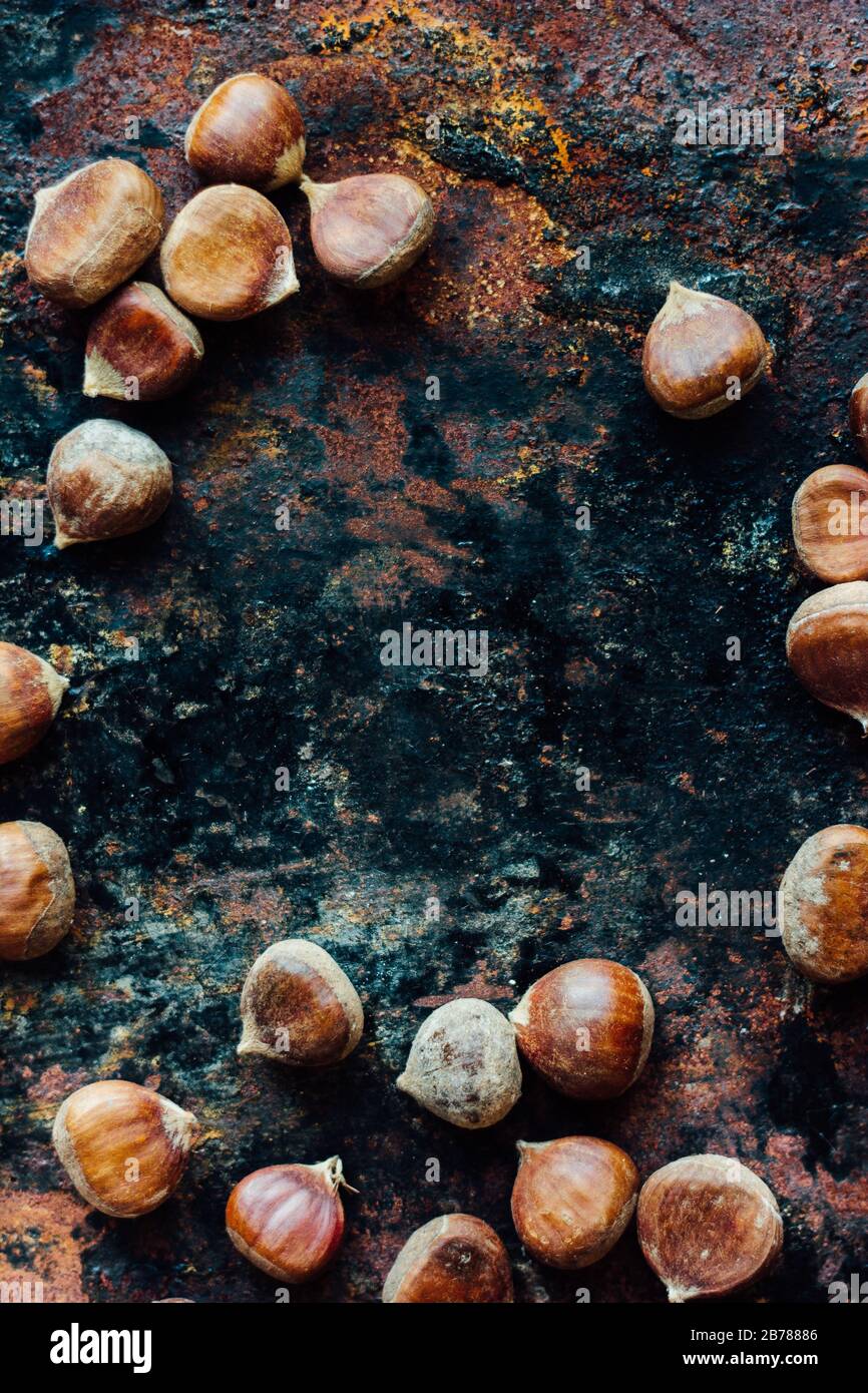 Chestnuts frame on black metal rustic surface Stock Photo - Alamy