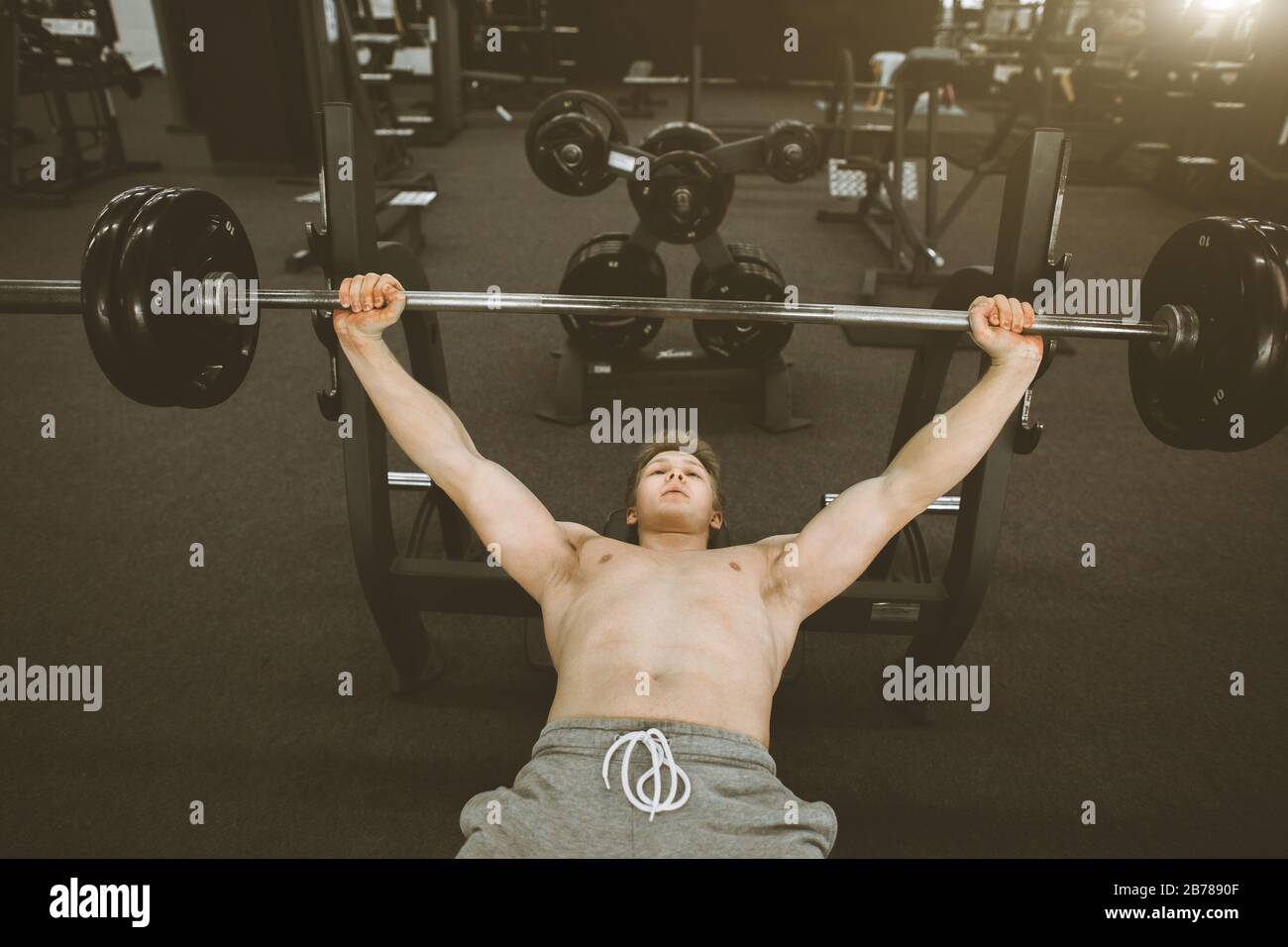 Sportsman doing exercise barbell biceps hi-res stock photography and ...