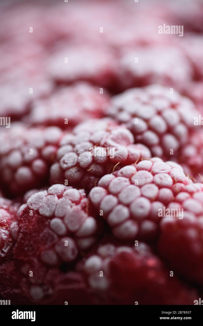 Food background. Freshly frozen raspberries, turned into a juicy piece ...