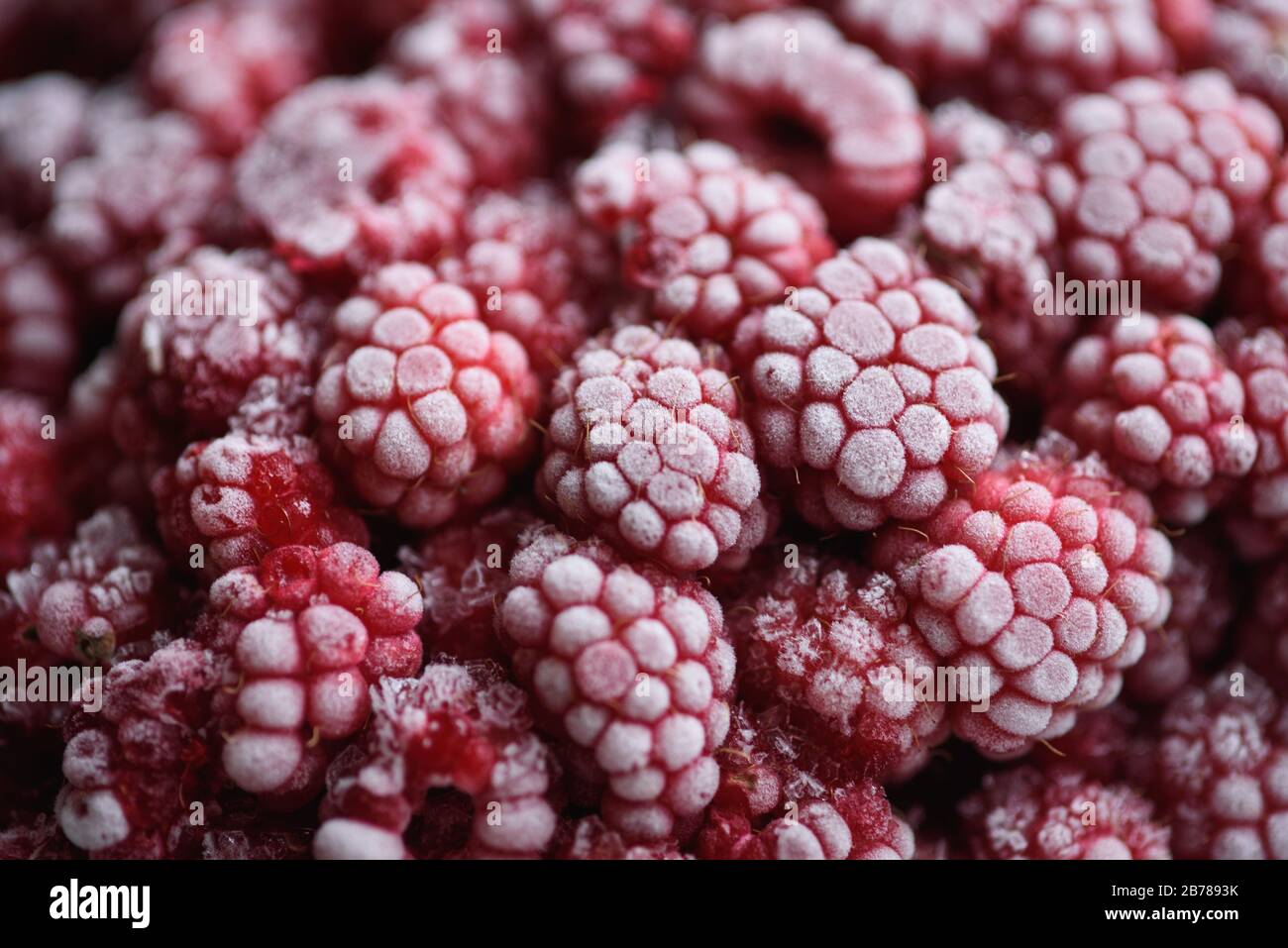 Food background. Freshly frozen raspberries, turned into a juicy piece ...
