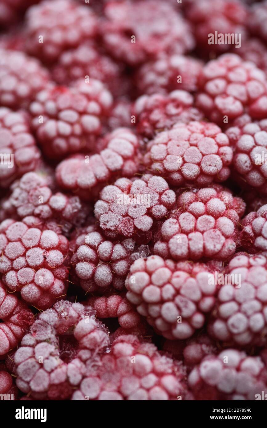 Food background. Freshly frozen raspberries, turned into a juicy piece ...