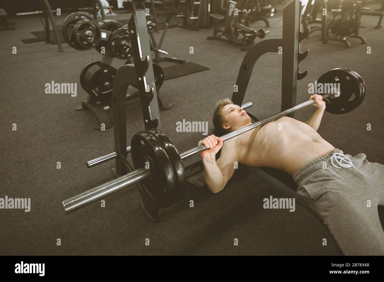 Sportsman doing exercise barbell biceps hi-res stock photography and ...