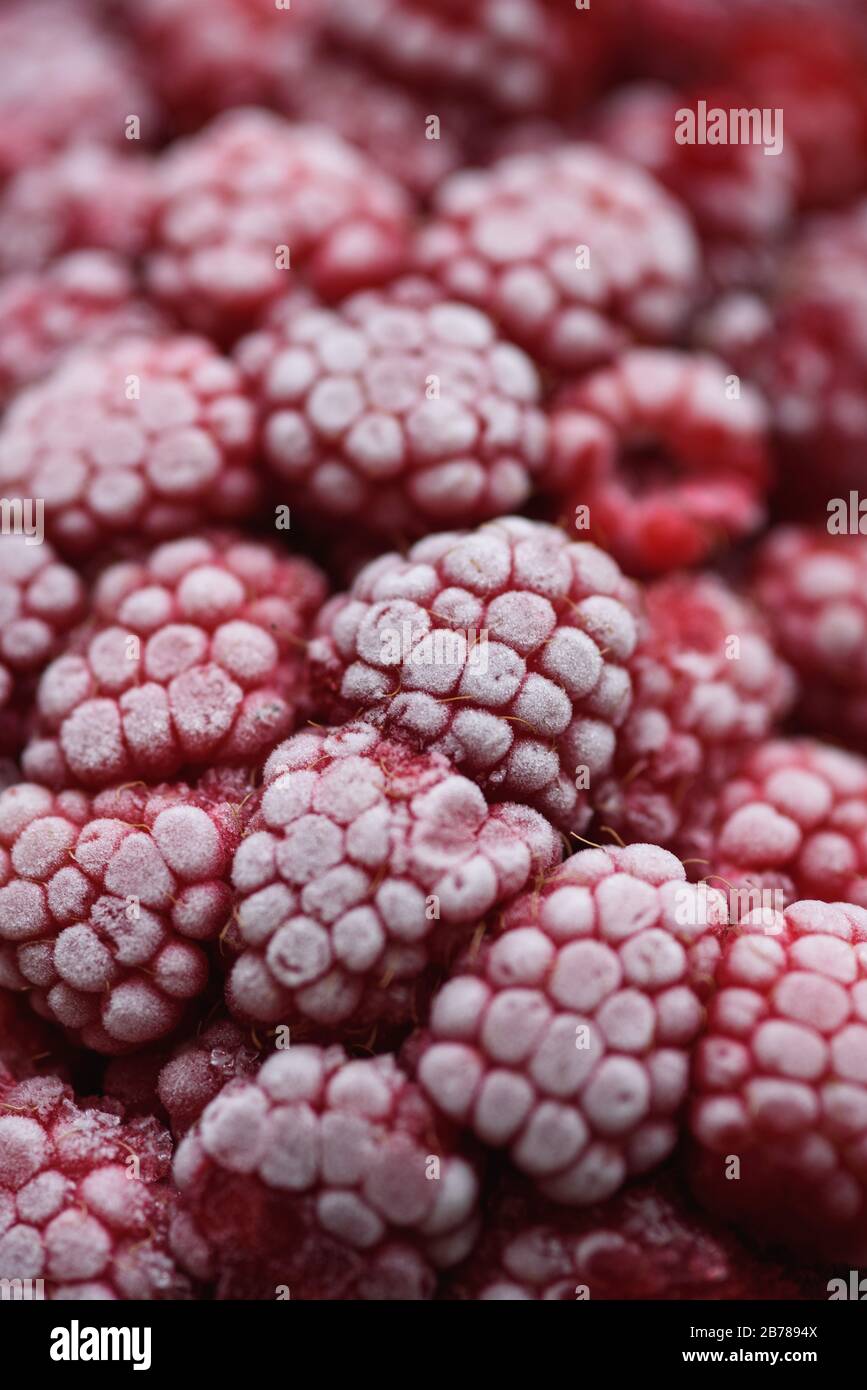 Food background. Freshly frozen raspberries, turned into a juicy piece ...