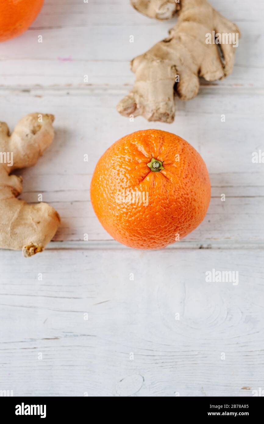 organic orange and ginger root on white surface Stock Photo - Alamy