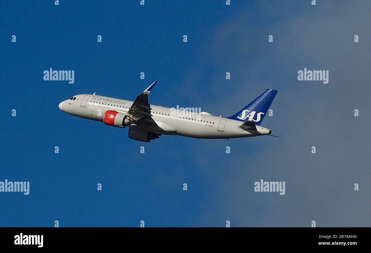 Flying Sas airplane in front of blue sky Stock Photo - Alamy