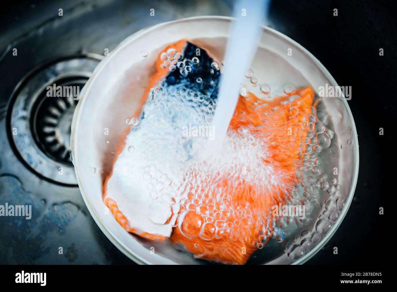 Clean water pouring washing inside kitchen stainless steel sink with ...