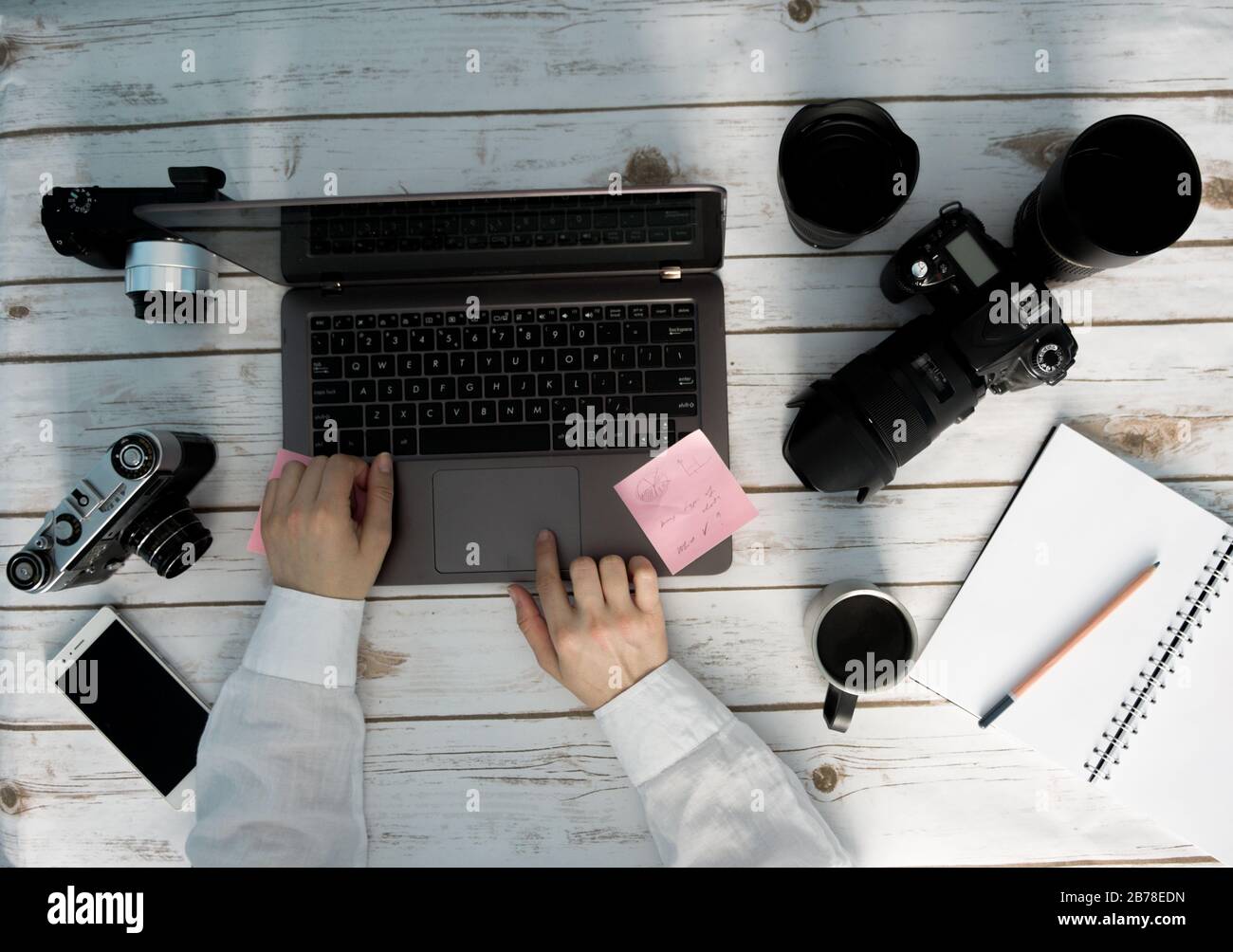 photographer work space - laptop and different cameras Stock Photo - Alamy