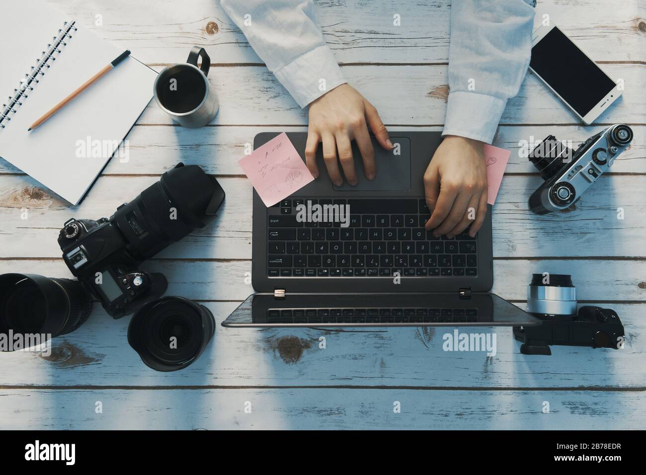 photographer work space - laptop and different cameras Stock Photo - Alamy