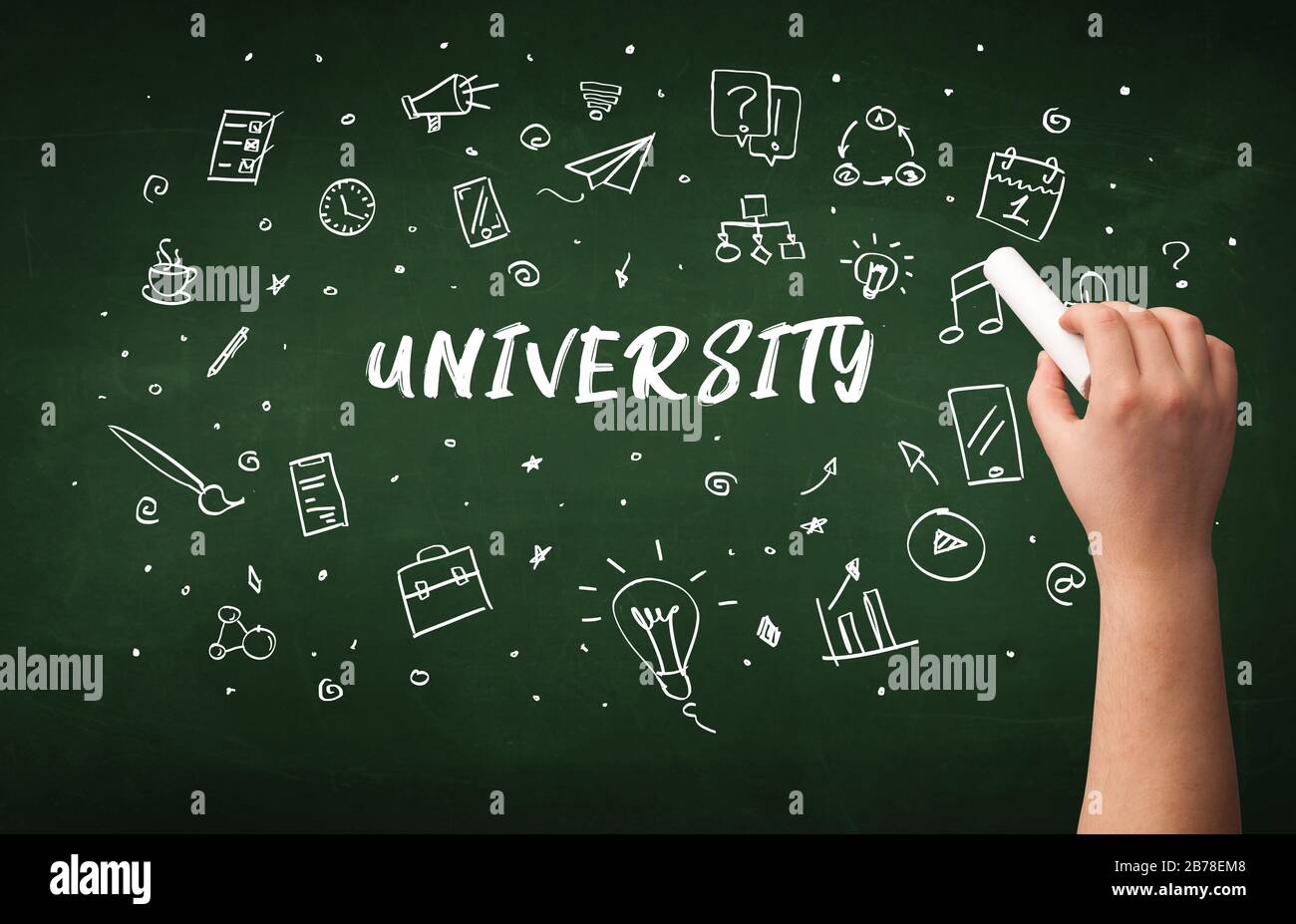 Hand drawing UNIVERSITY inscription with white chalk on blackboard ...