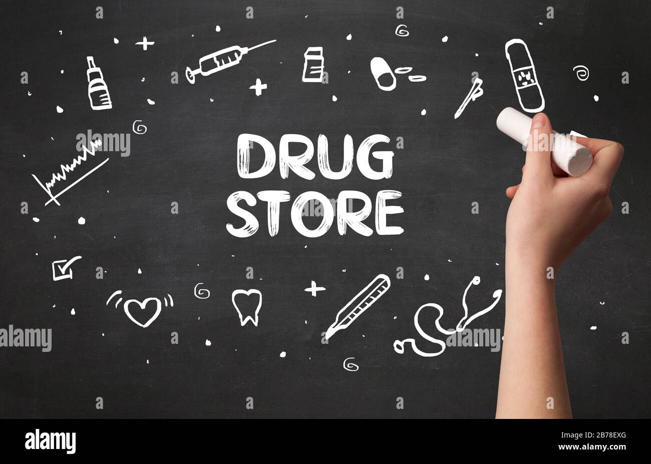 Hand drawing DRUG STORE inscription with white chalk on blackboard ...