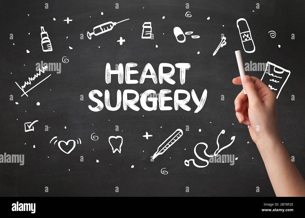 Hand drawing HEART SURGERY inscription with white chalk on blackboard ...