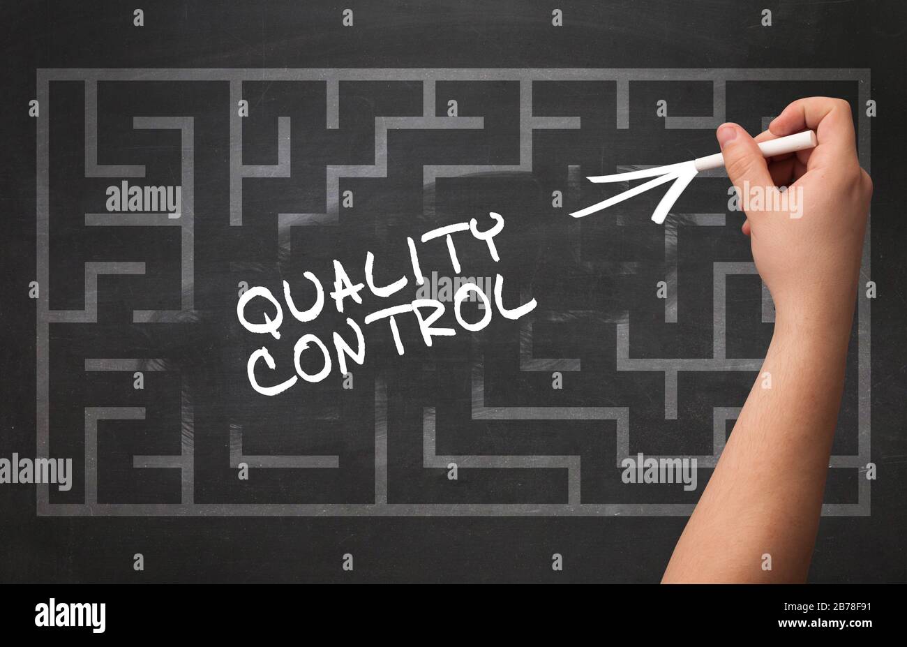 Hand drawing QUALITY CONTROL inscription with white chalk on blackboard ...